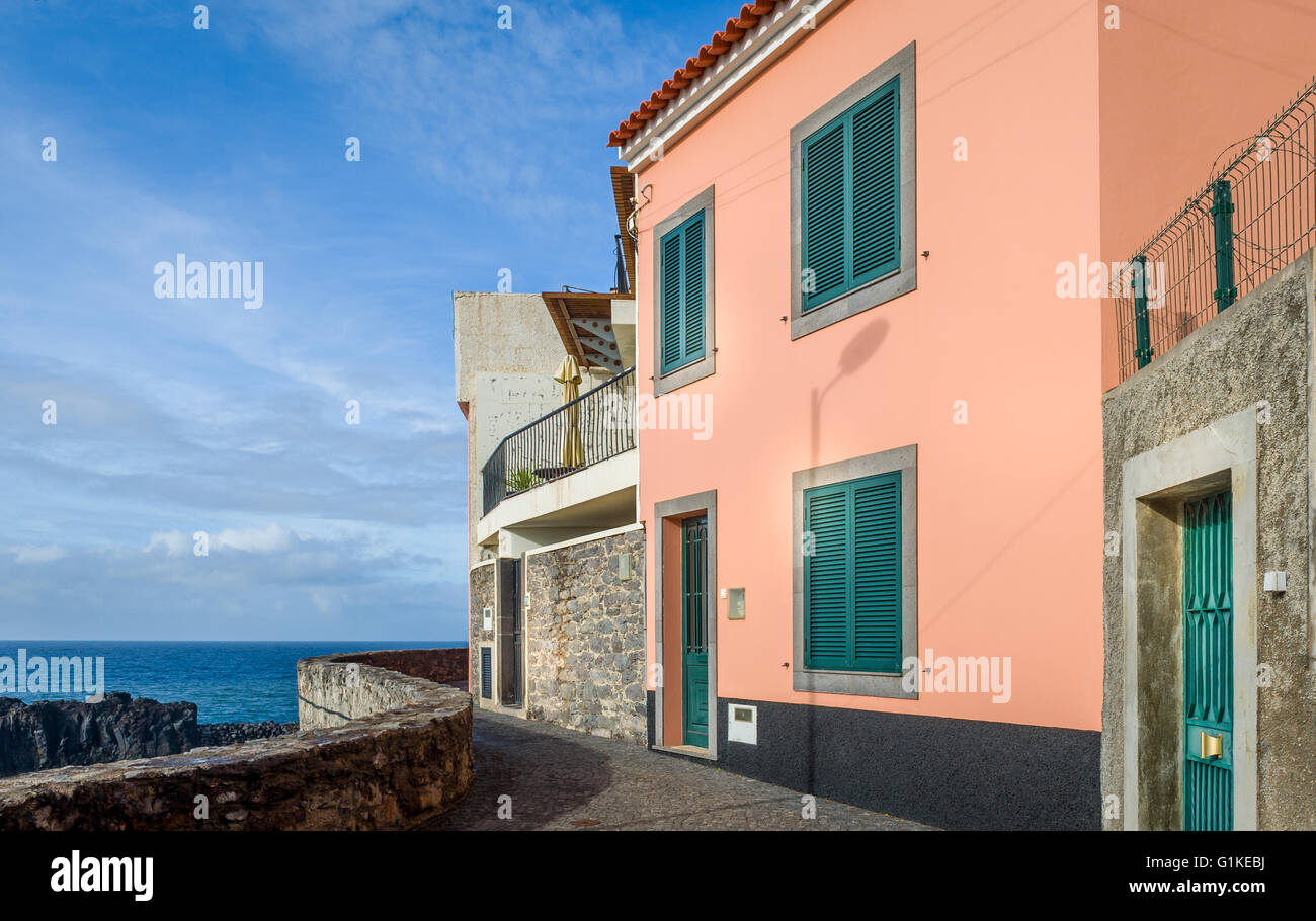Traditional colorful house on the ocean cliff Stock Photo - Alamy