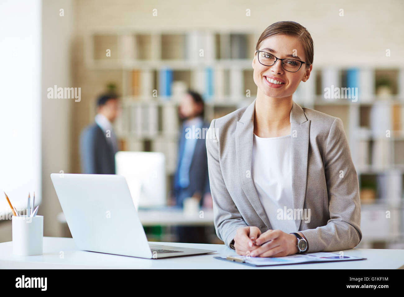 Friendly smiling young business woman hi-res stock photography and ...
