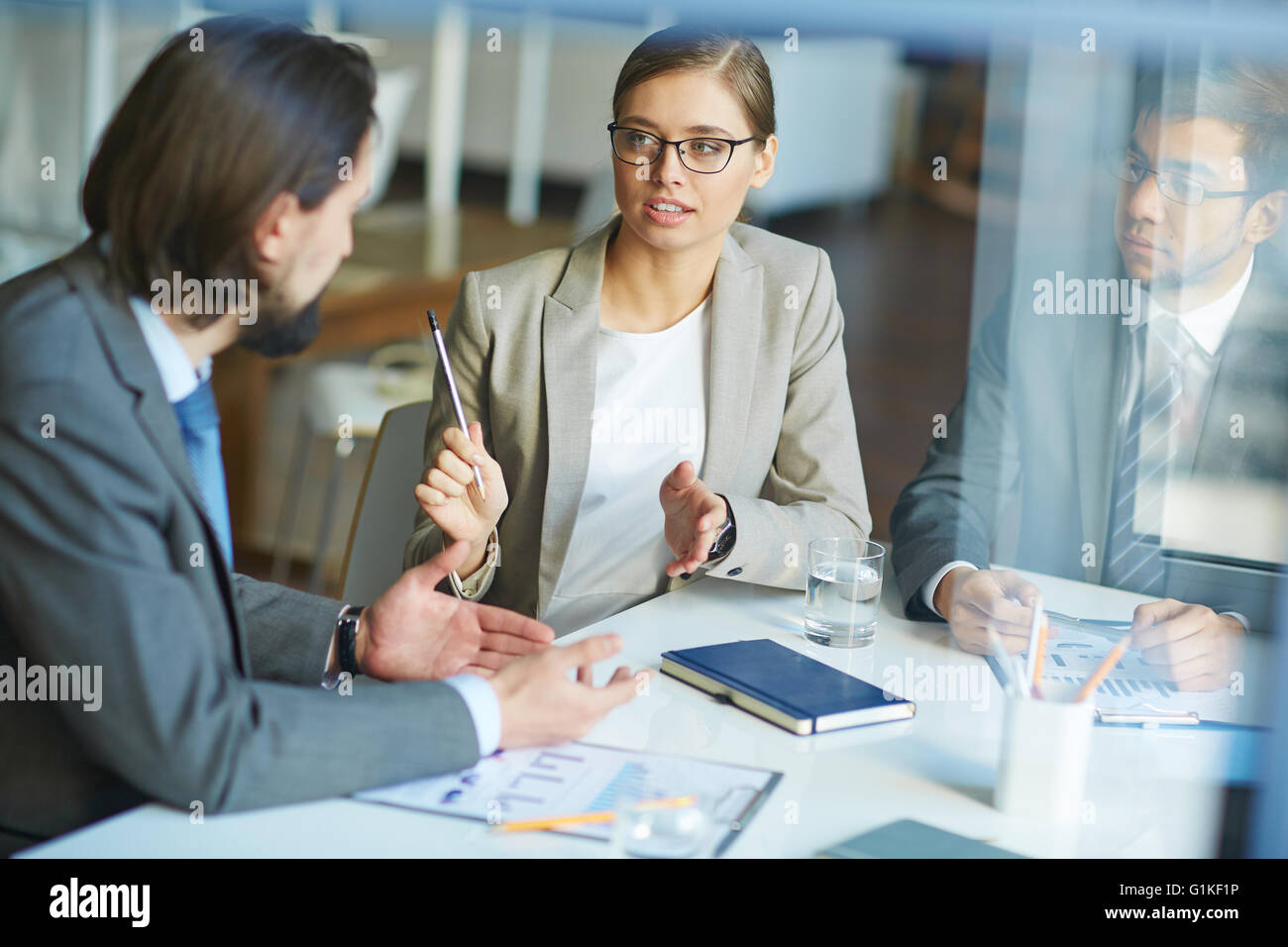 Conversation of colleagues Stock Photo - Alamy