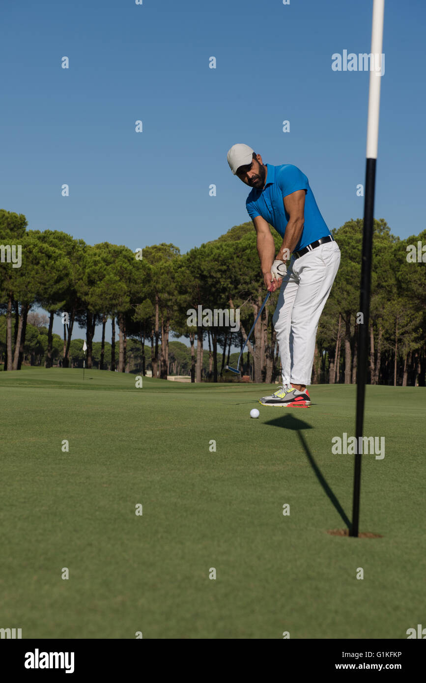 golf player hitting shot with driver on course at beautiful sunny day ...