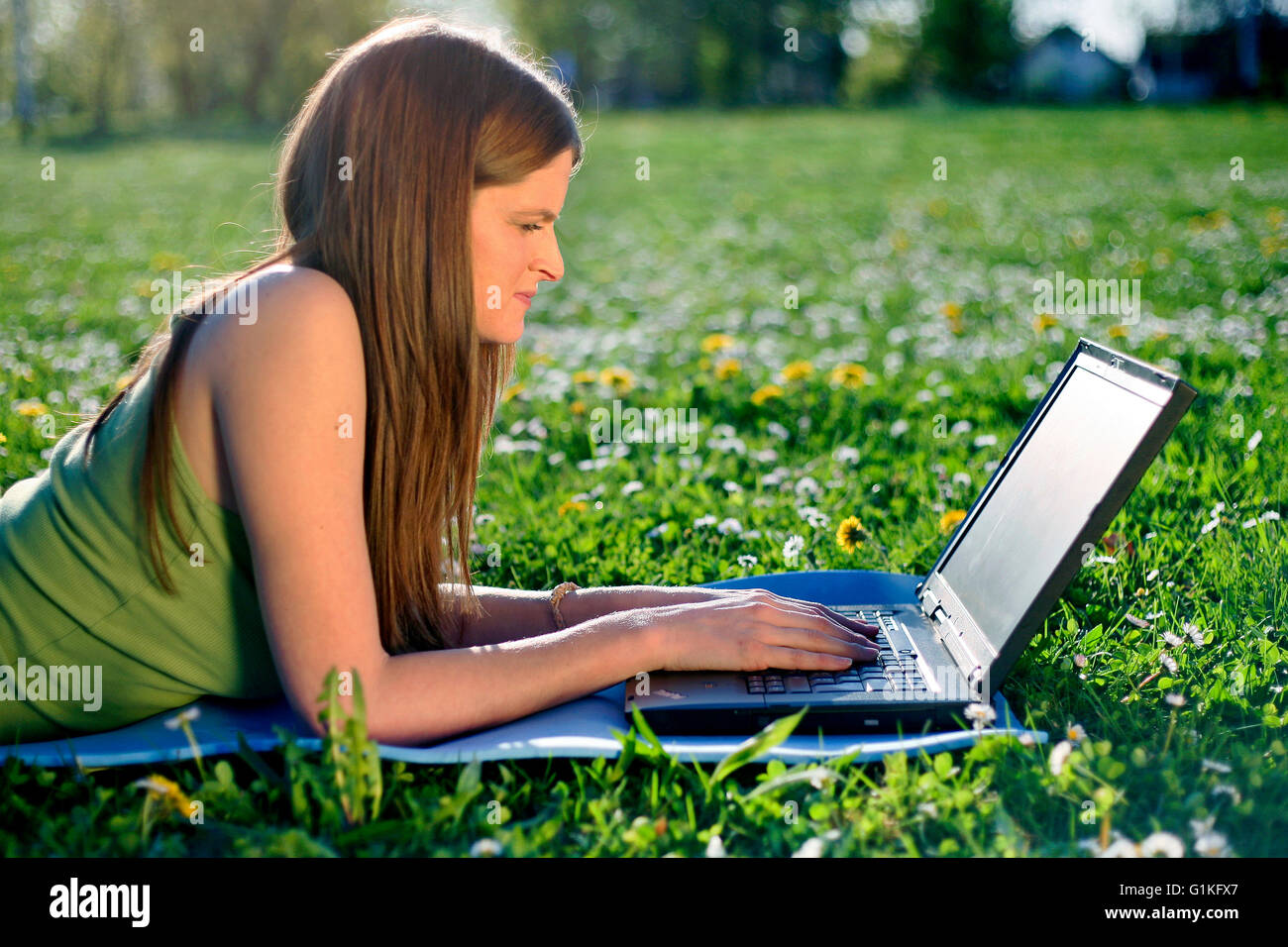 Woman working on laptop outside Stock Photo - Alamy