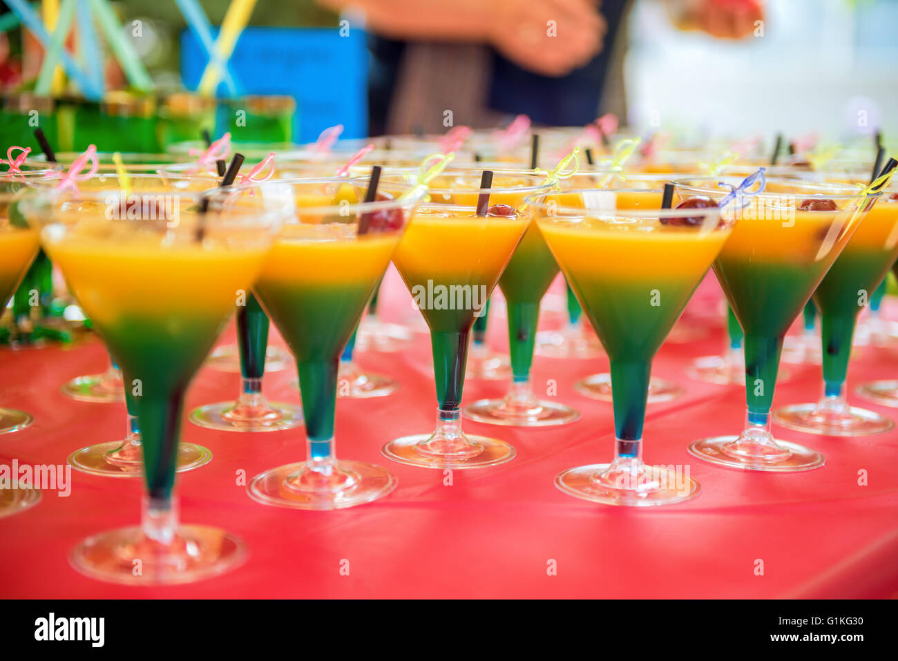 yellow green cocktail with cherry and drinking straw in summer Stock ...