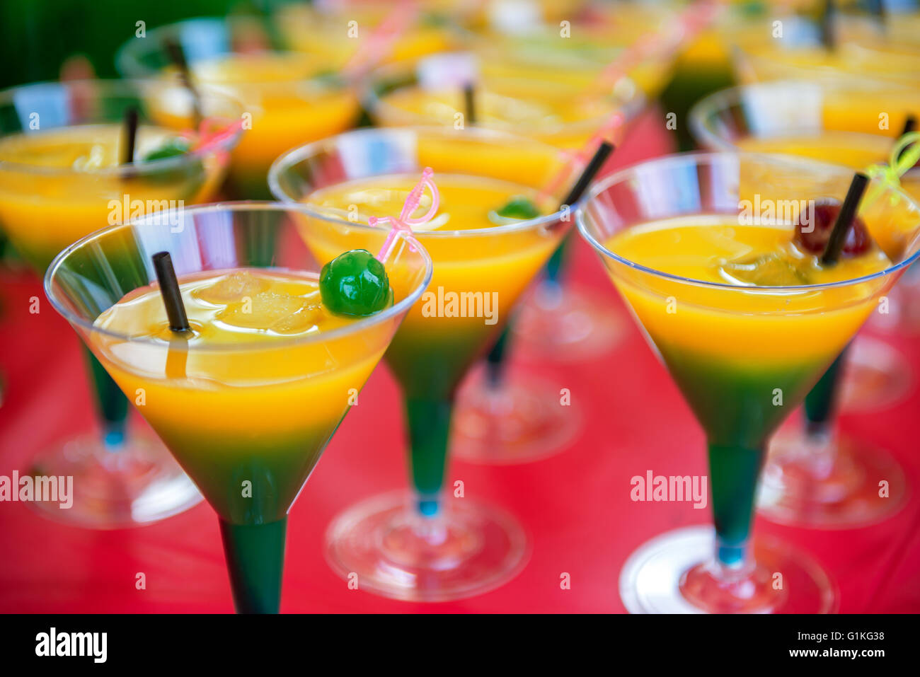 yellow green cocktail with cherry and drinking straw in summer Stock ...