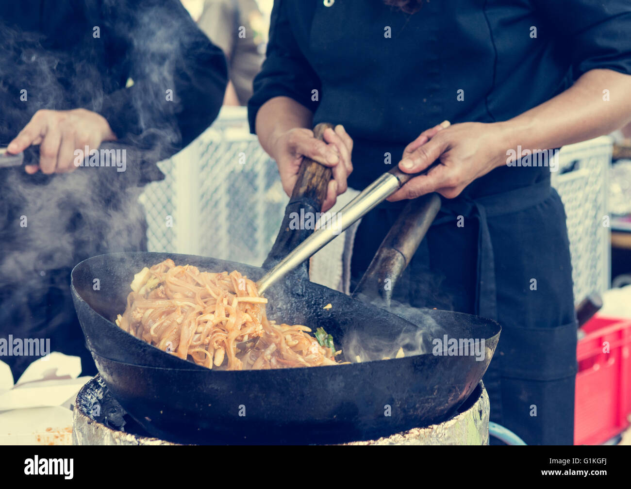 Chef making tasty noodles in a wok Stock Photo - Alamy