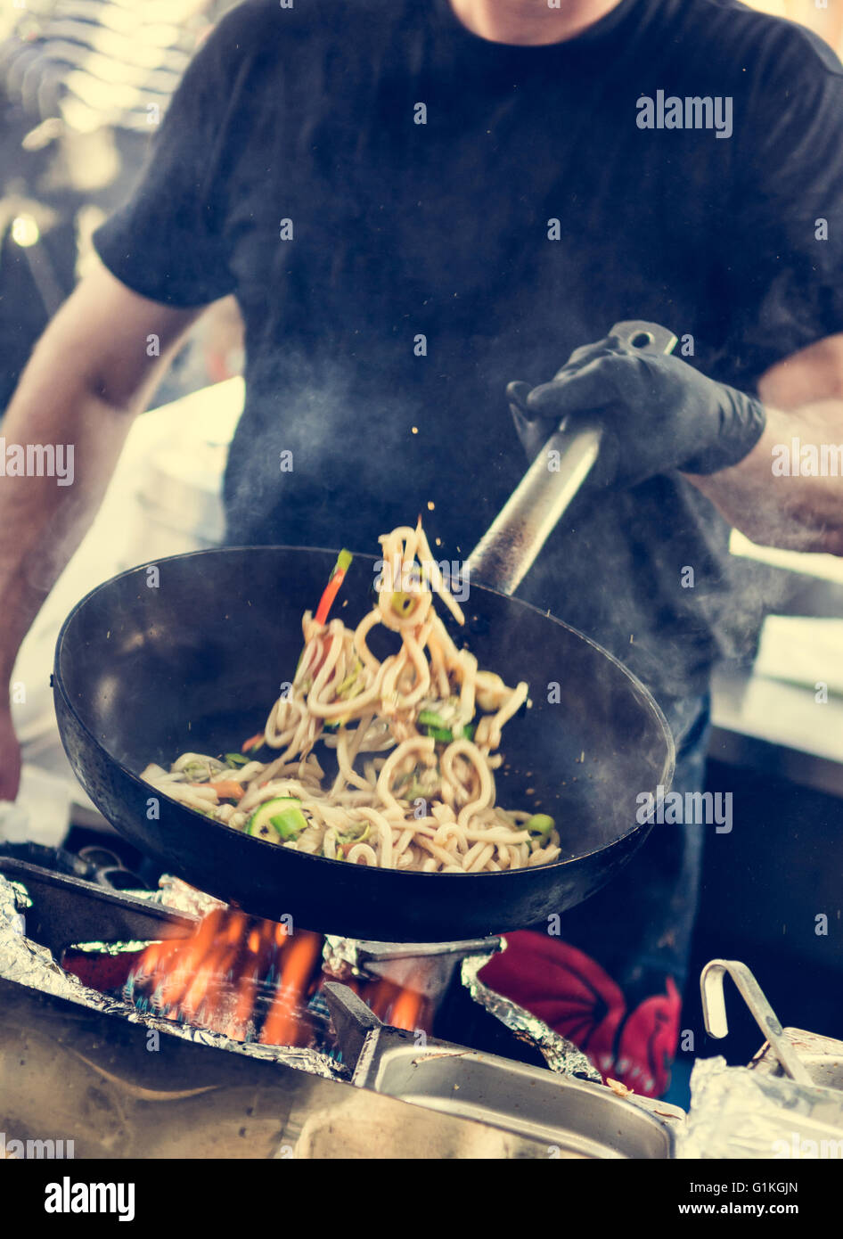 Chef making tasty noodles in a wok Stock Photo - Alamy
