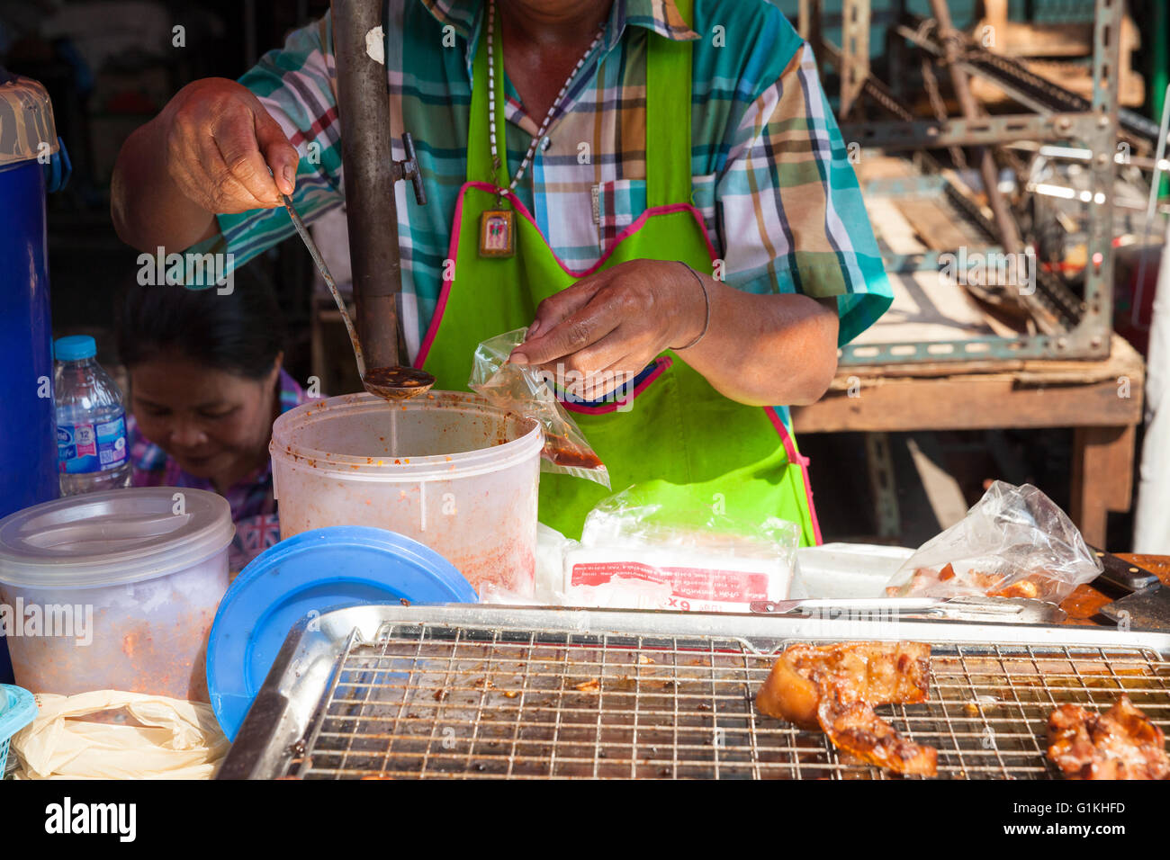 BANGKOK, THAILAND - APRIL 24: Thai man cooks on the street on April 24 ...