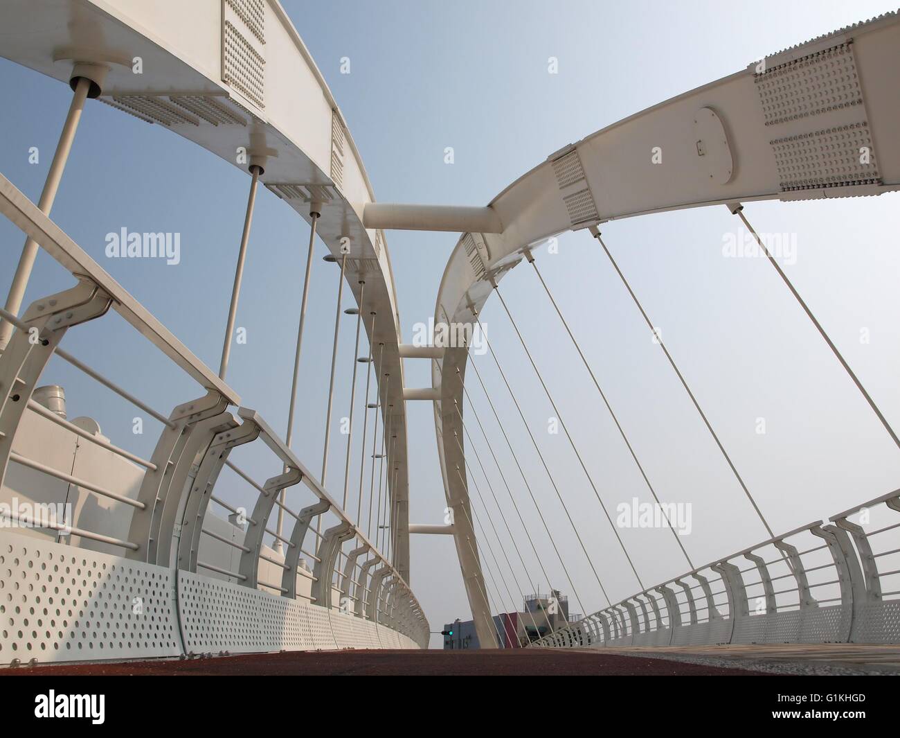 A modern arch bridge for cyclists and pedestrians Stock Photo - Alamy