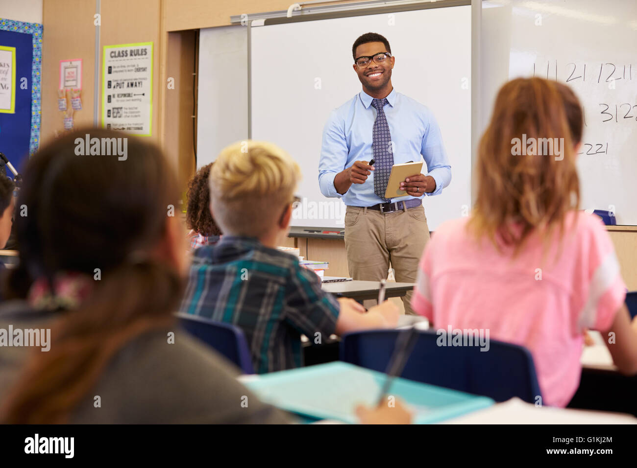 Schoolboy using computer teacher hi-res stock photography and images ...