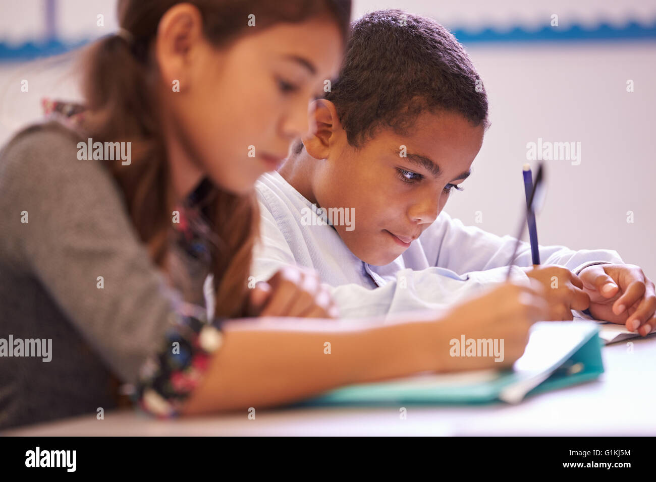 African american kids writing at a desk hi-res stock photography and ...