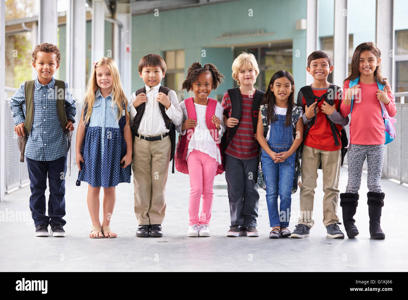 Group of elementary school kids standing in school corridor Stock Photo ...