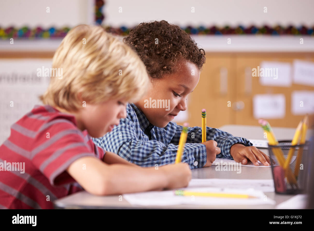 Two primary school kids working in class hi-res stock photography and ...