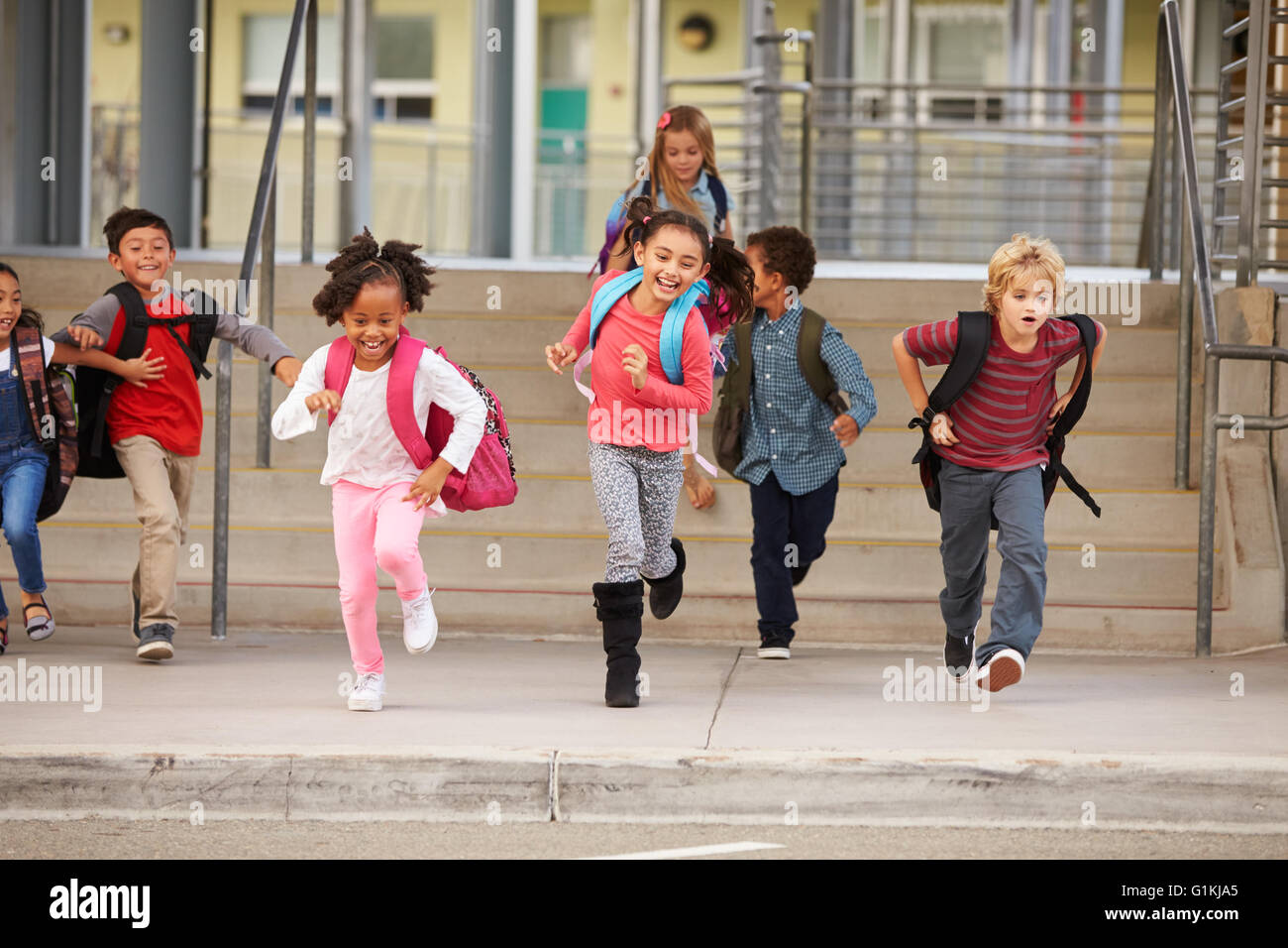 A group of elementary school kids rushing out of school Stock Photo - Alamy