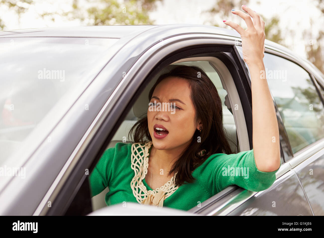 Frustrated female Asian driver in a car Stock Photo - Alamy