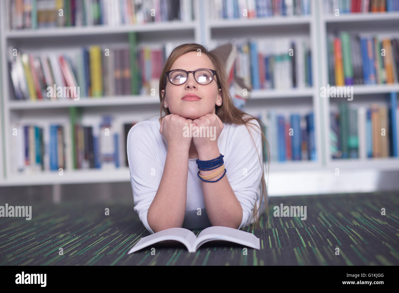 female student study in school library, using tablet and searching for ...