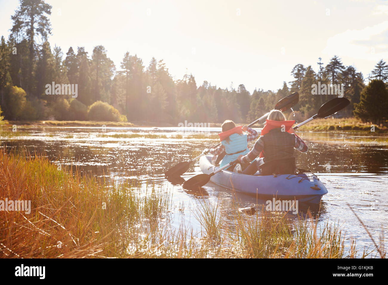 Mother and daughter kayaking on lake, back view Stock Photo - Alamy