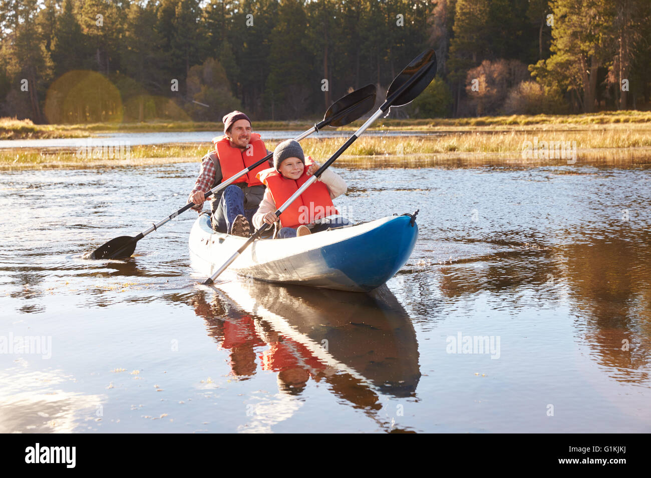 Father and son kayaking on lake, Big Bear, California, USA Stock Photo ...