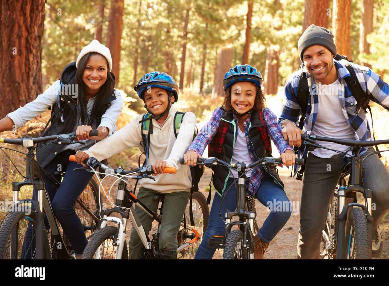 Portrait Of Family Cycling Through Fall Woodland Stock Photo - Alamy