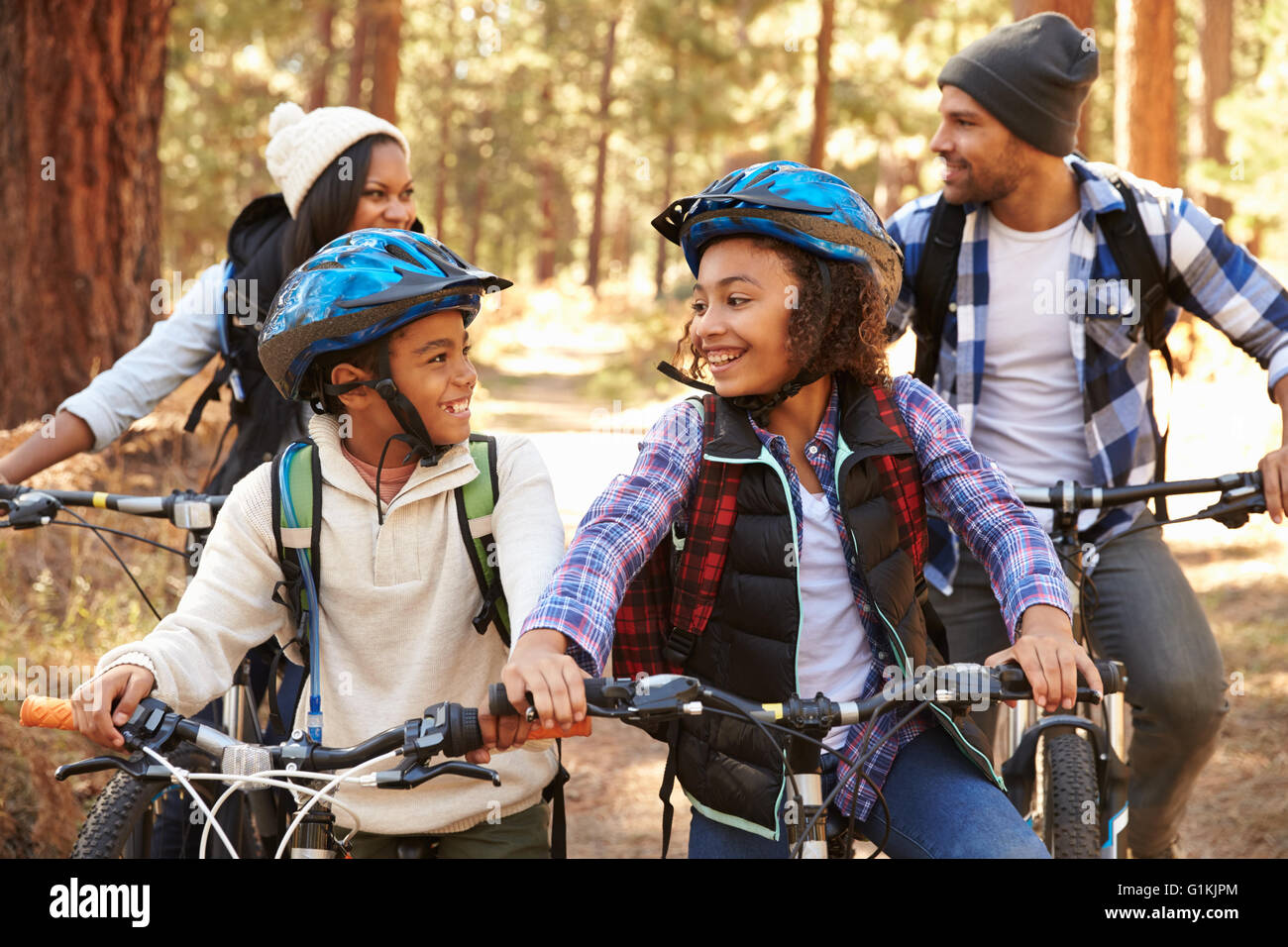 African American Family Cycling Through Fall Woodland Stock Photo - Alamy