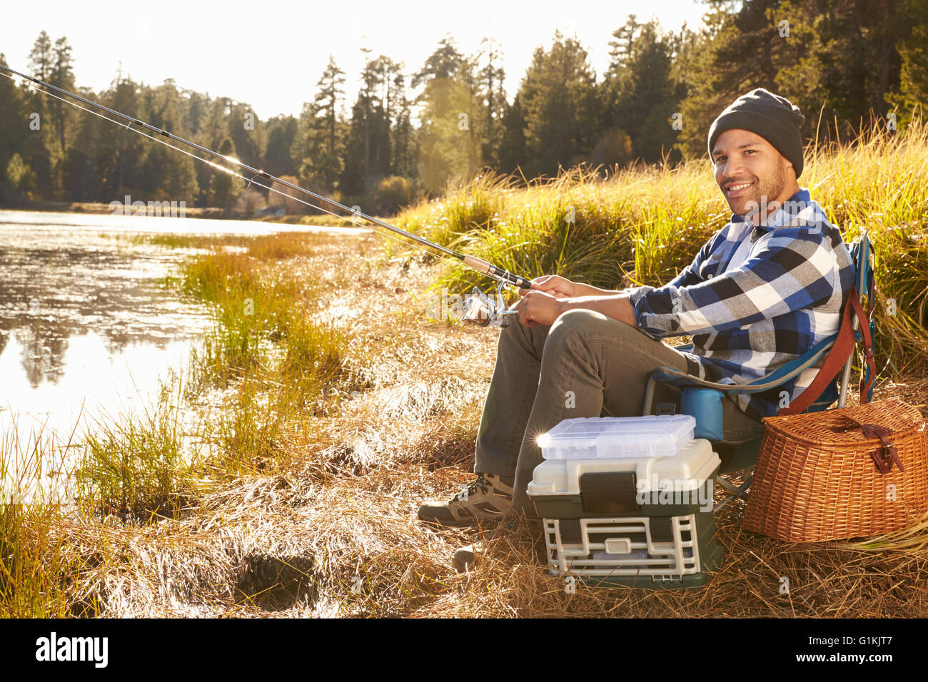 African American Man Fishing By Lake Stock Photo - Alamy