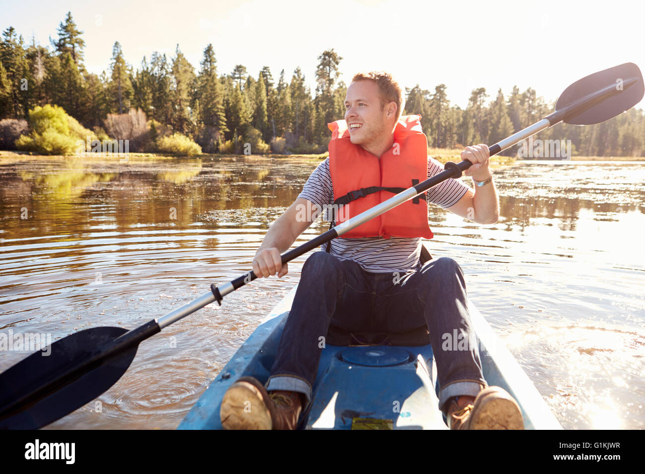 Man Wearing Life Preserver Rowing Kayak On Lake Stock Photo - Alamy