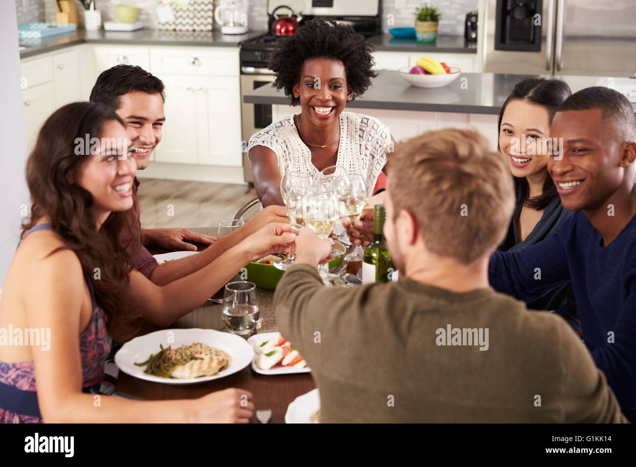 Group Of Friends Making A Toast At Dinner Party Stock Photo - Alamy