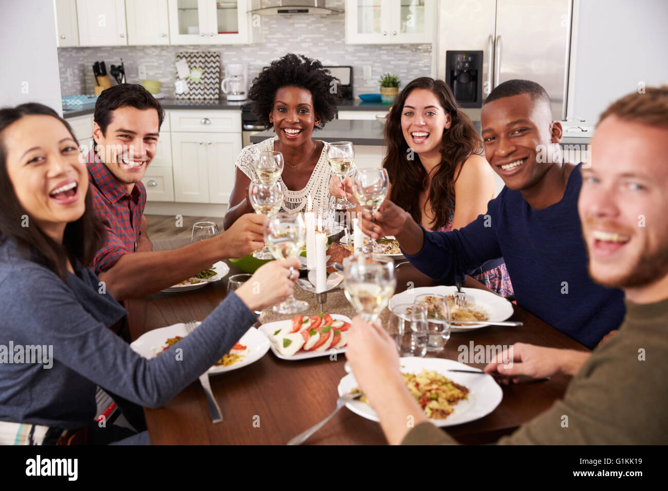 Group Of Friends Making A Toast At Dinner Party Stock Photo - Alamy