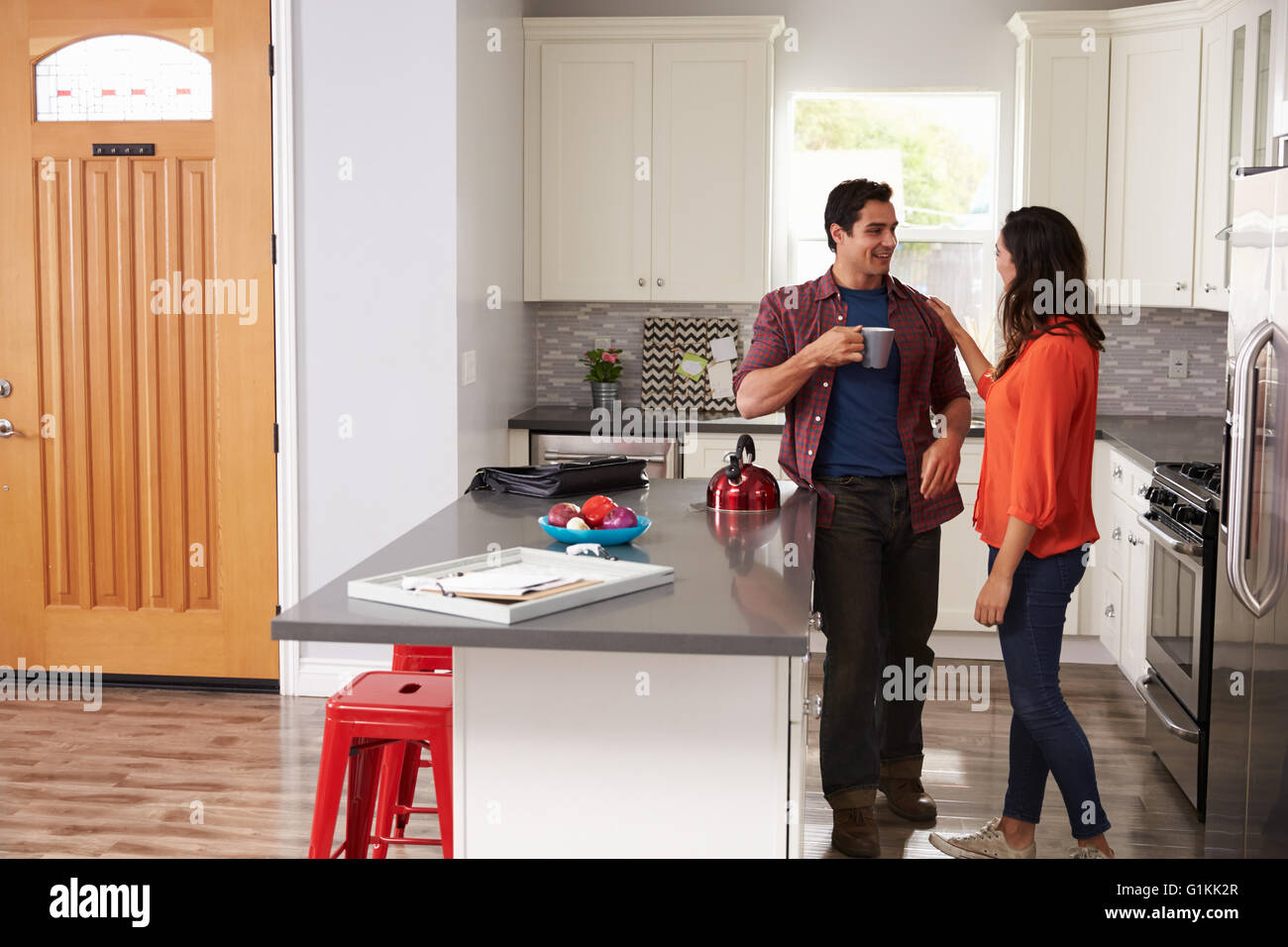 Woman Greeting Man Returning Home From Work Stock Photo - Alamy