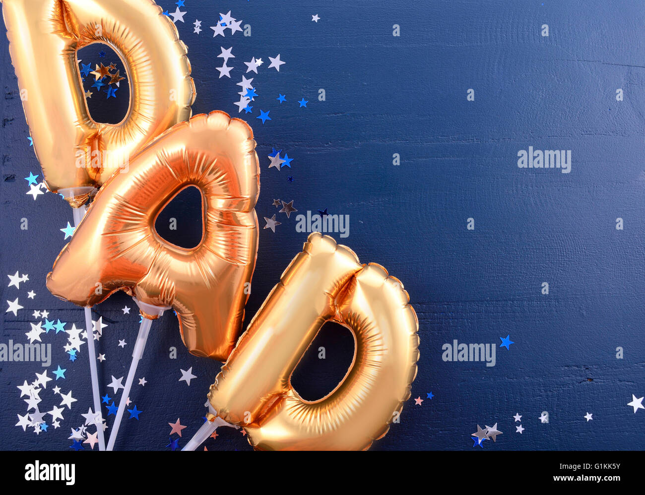 Happy Fathers Day gold balloons for the word, Dad, on dark blue wood ...