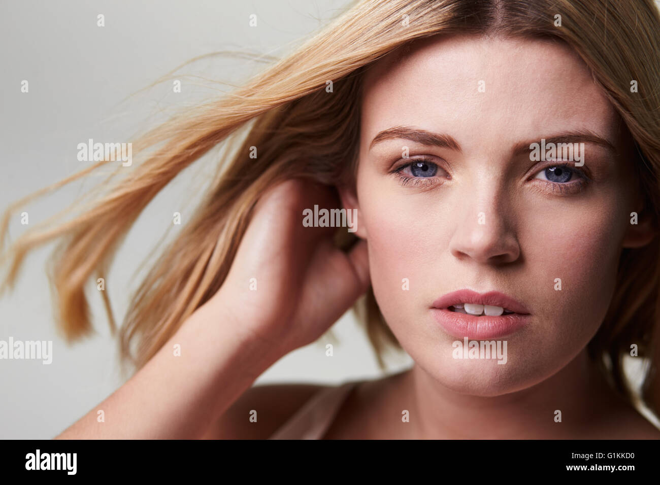 Blonde woman looking to camera, hair blowing, horizontal Stock Photo ...