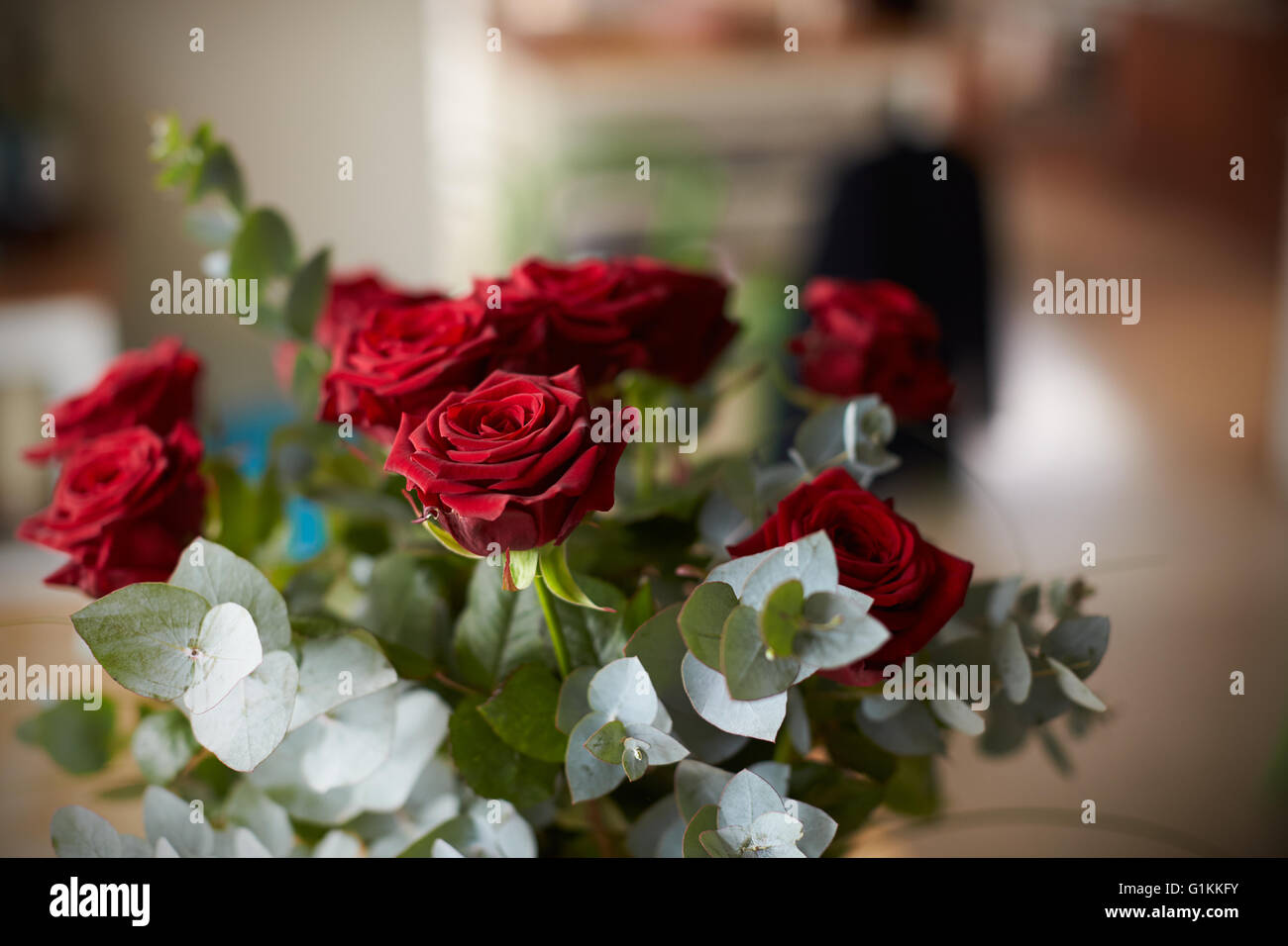 Arrangement Of Red Roses On Table Stock Photo - Alamy