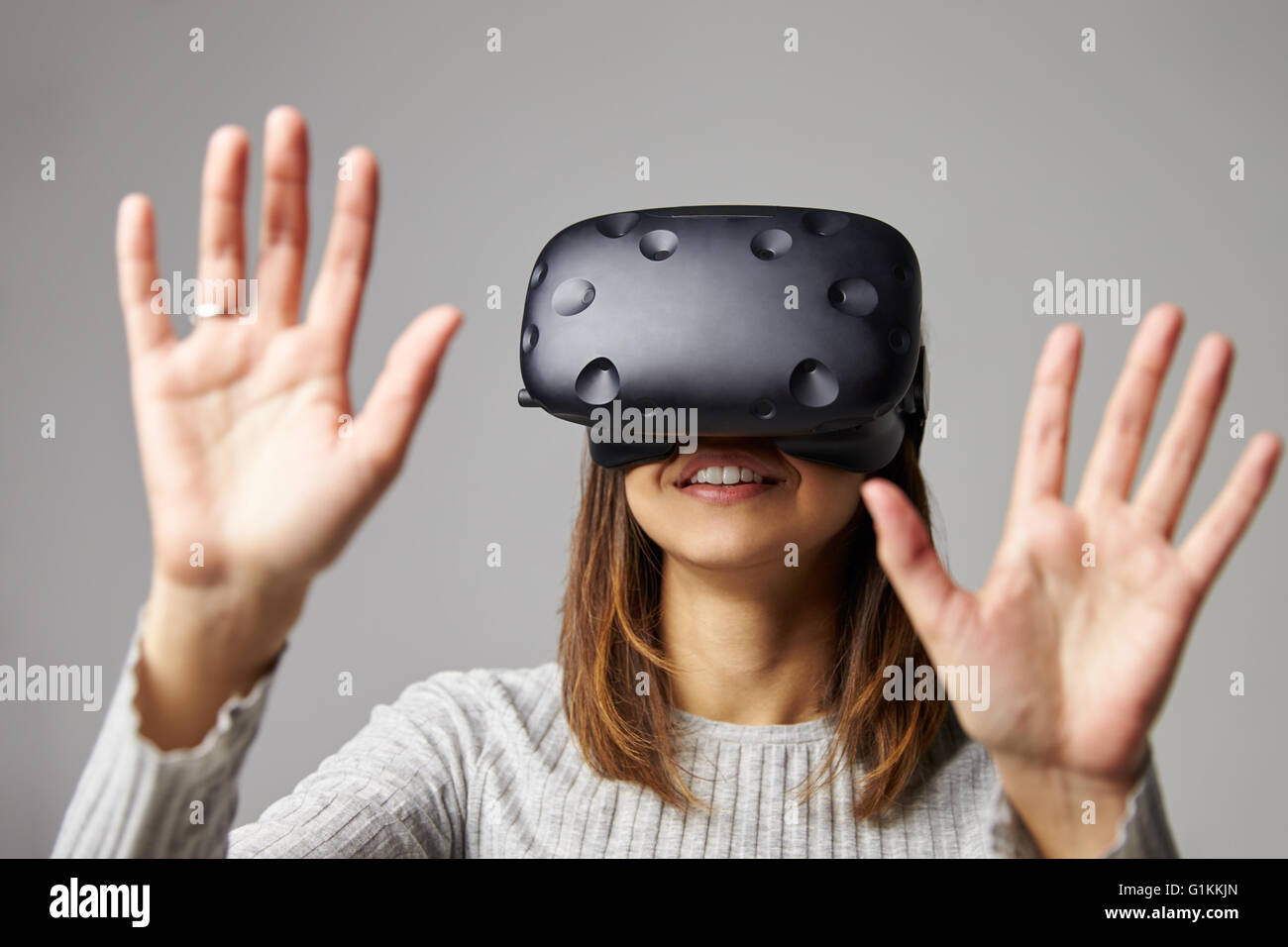 Woman Sits On Sofa At Home Wearing Virtual Reality Headset Stock Photo ...