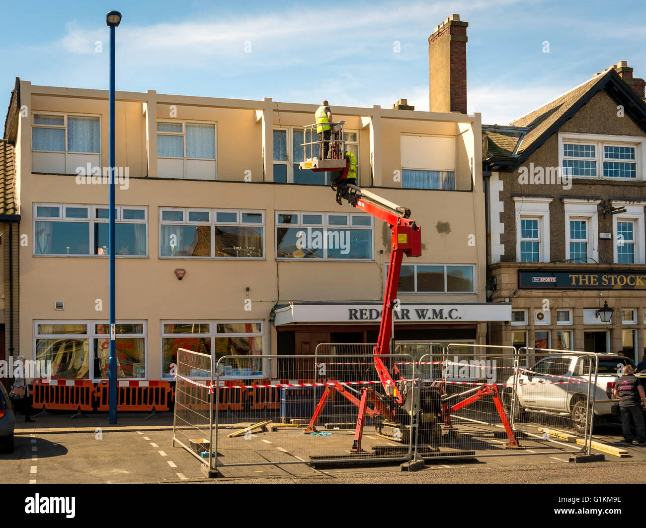 Decorators using an hydraulic access platform for painting the exterior ...