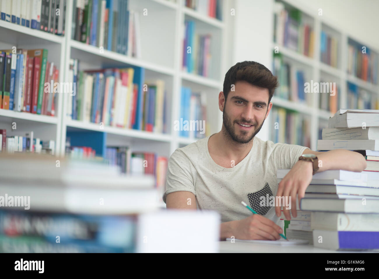 Student reading book in school library. Study lessons for exam. Hard ...