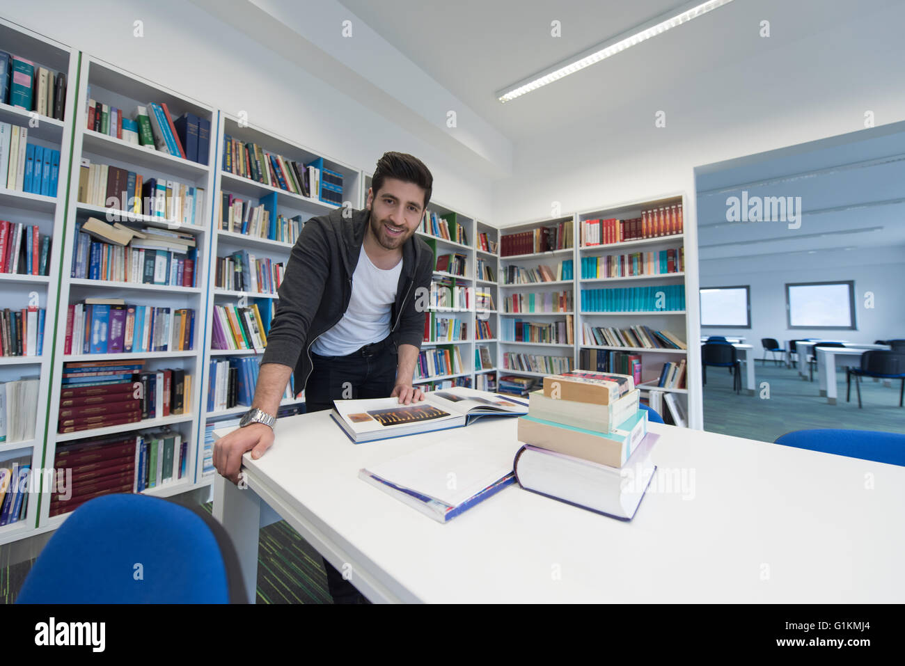 Student reading book in school library. Study lessons for exam. Hard ...