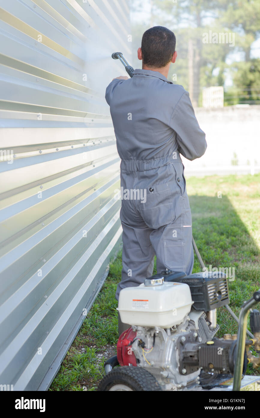 Man power washing the side of a building Stock Photo - Alamy