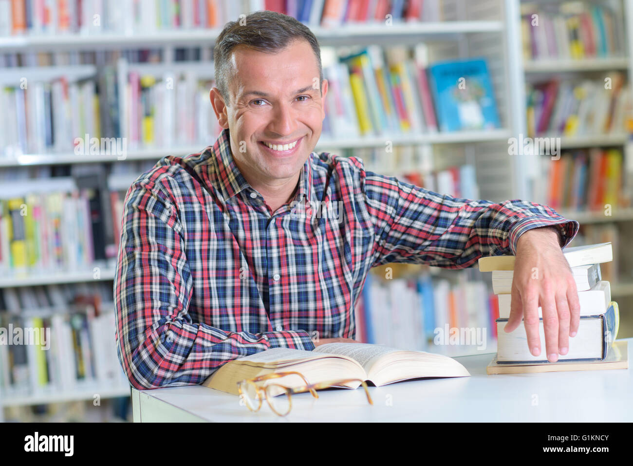 Portrait of man in library Stock Photo - Alamy