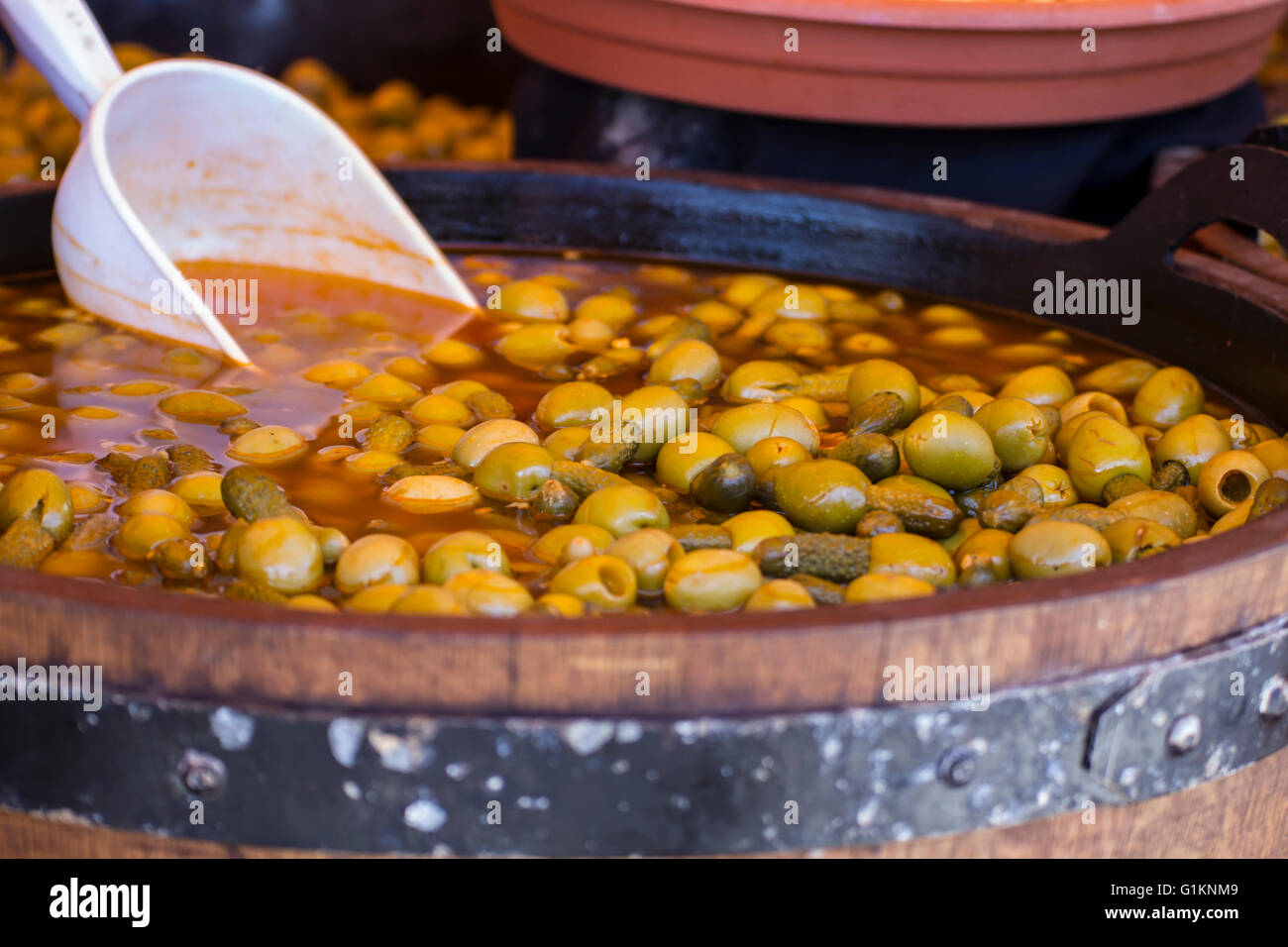 Mediterranean, Wooden drums with olives and variants Stock Photo - Alamy