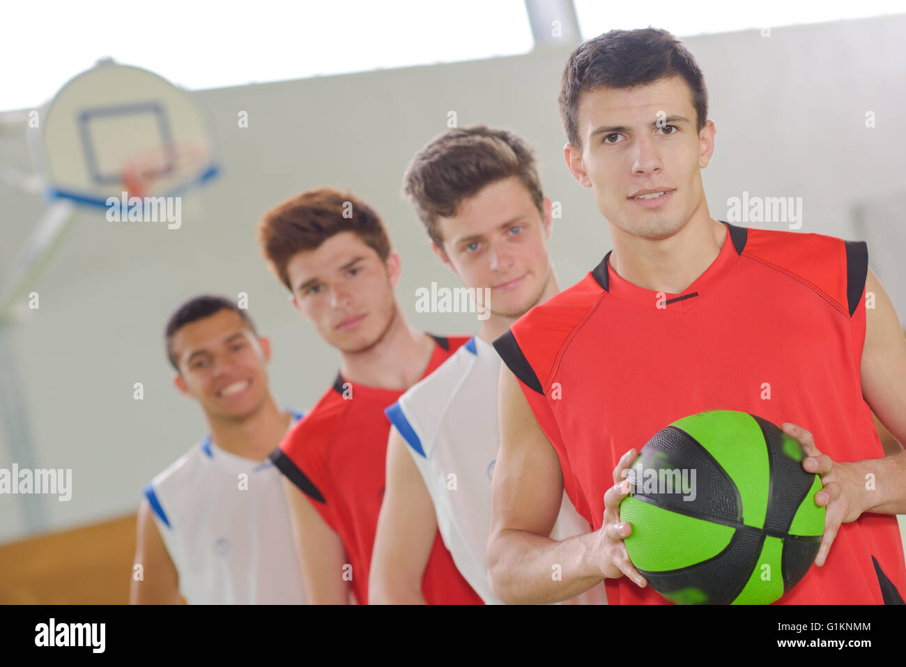 Portrait of four men on basketball court Stock Photo - Alamy