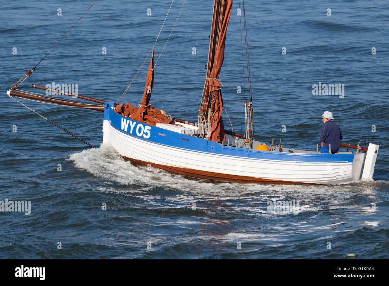 A boat setting sail for the North Sea from Whitby Harbour Stock Photo ...