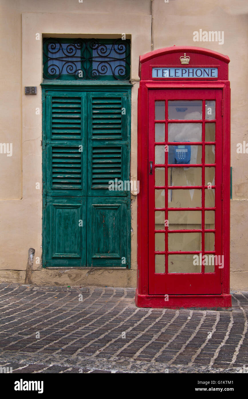 Traditional english style of a red telephone cabin. In the background ...
