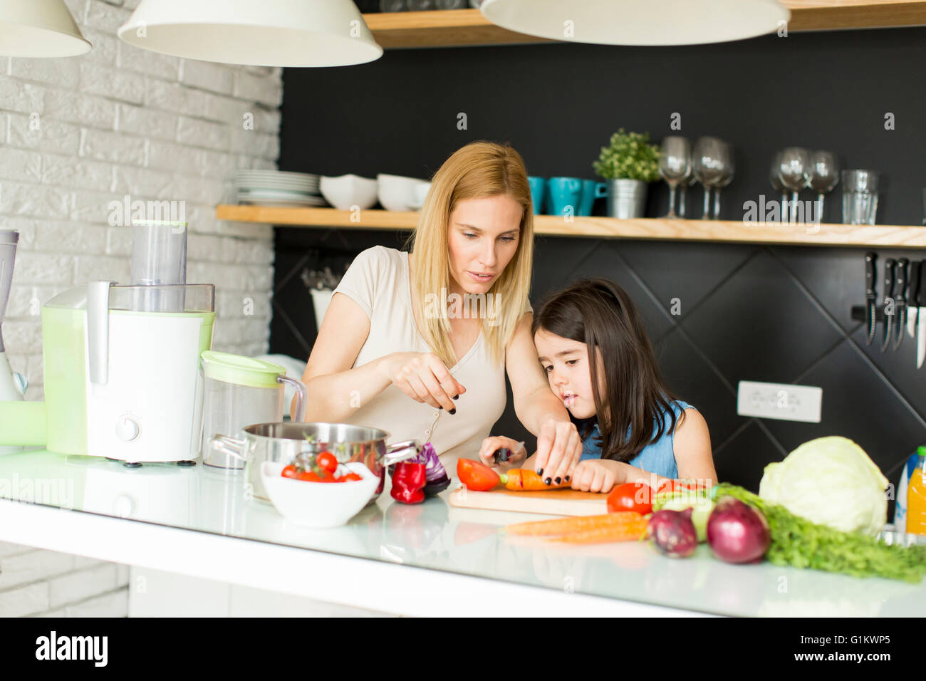 Mother and daughter preparing vegetables in the kitchen Stock Photo - Alamy