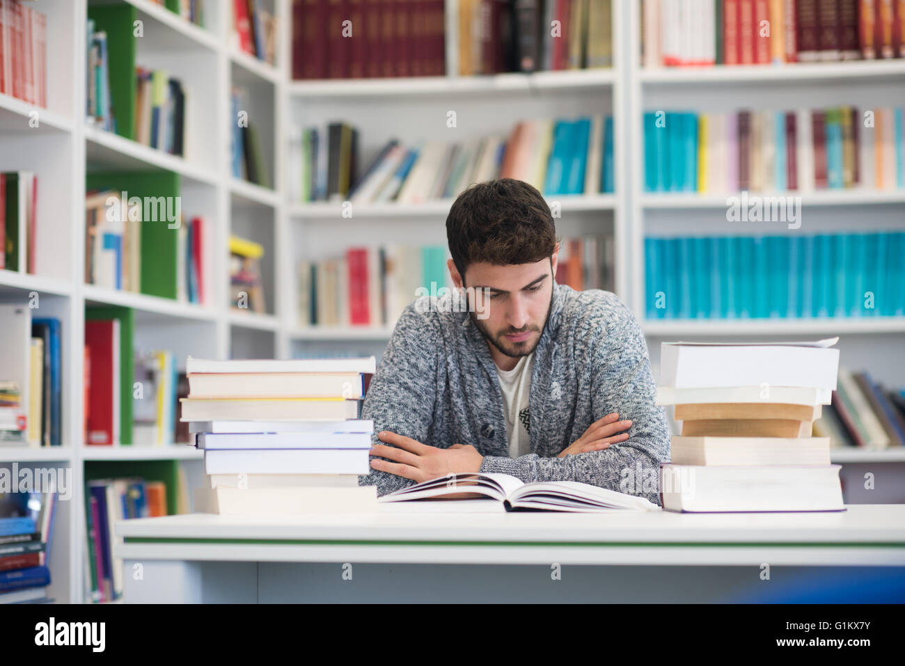 Portrait of happy student while reading book in school library. Study ...