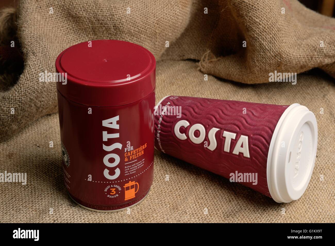 A tin of roasted and ground Costa coffee and a takeaway coffee cup on a ...