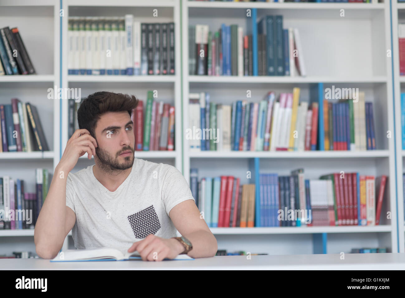 Student reading book in school library. Study lessons for exam. Hard ...