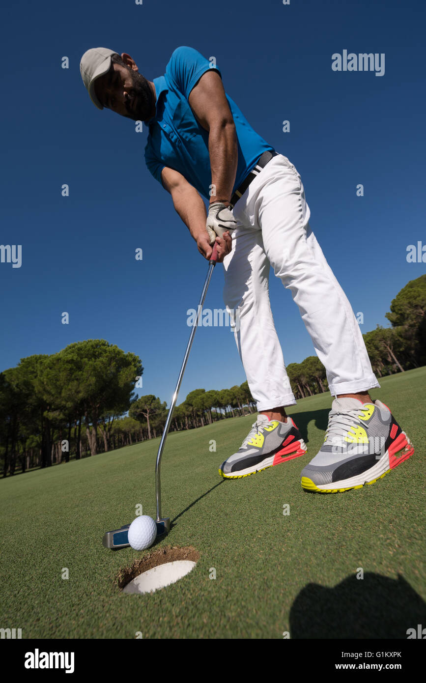golf player hitting shot with driver on course at beautiful sunny day ...