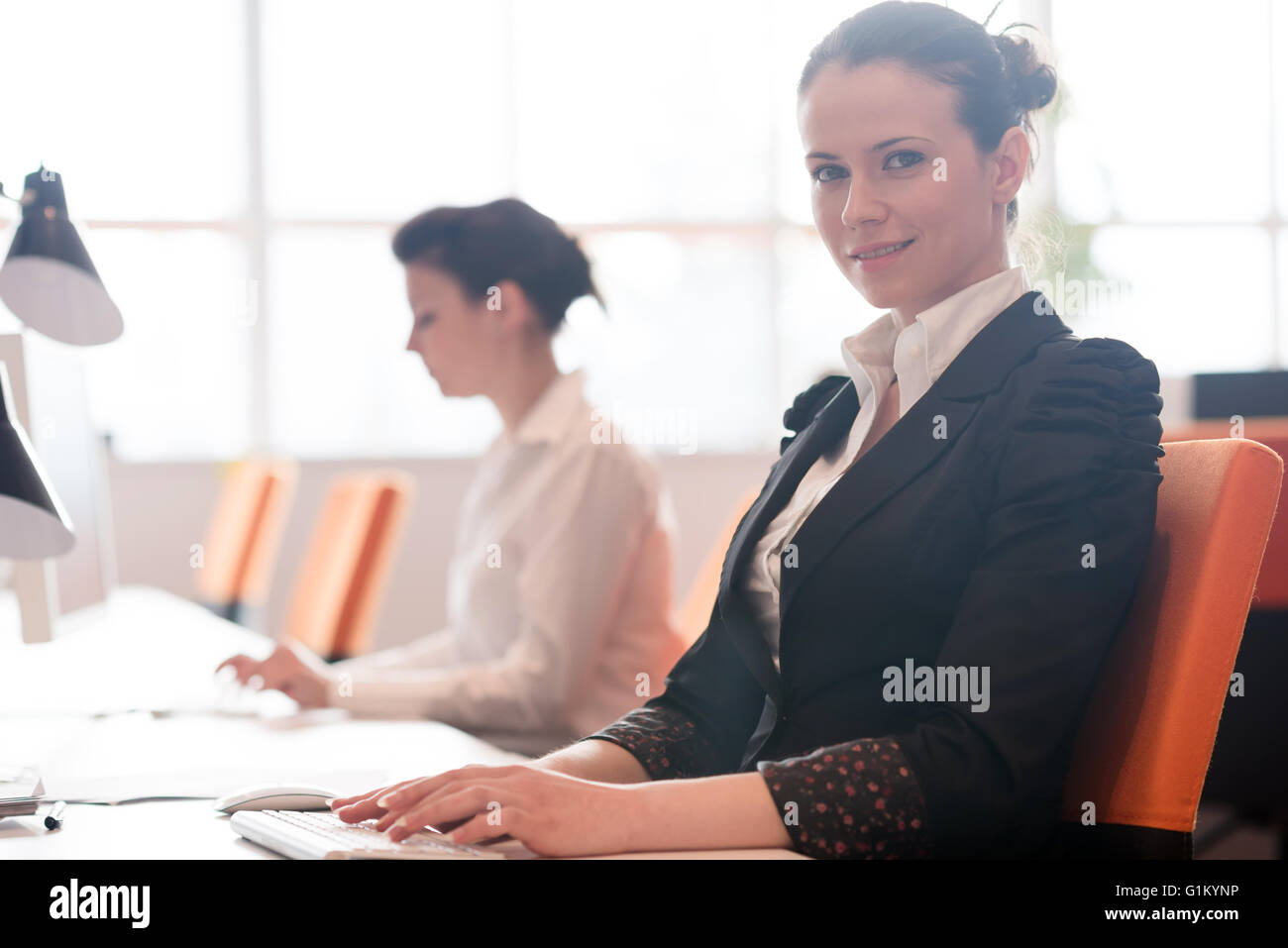 business woman working on desktop computer at modern startup office ...