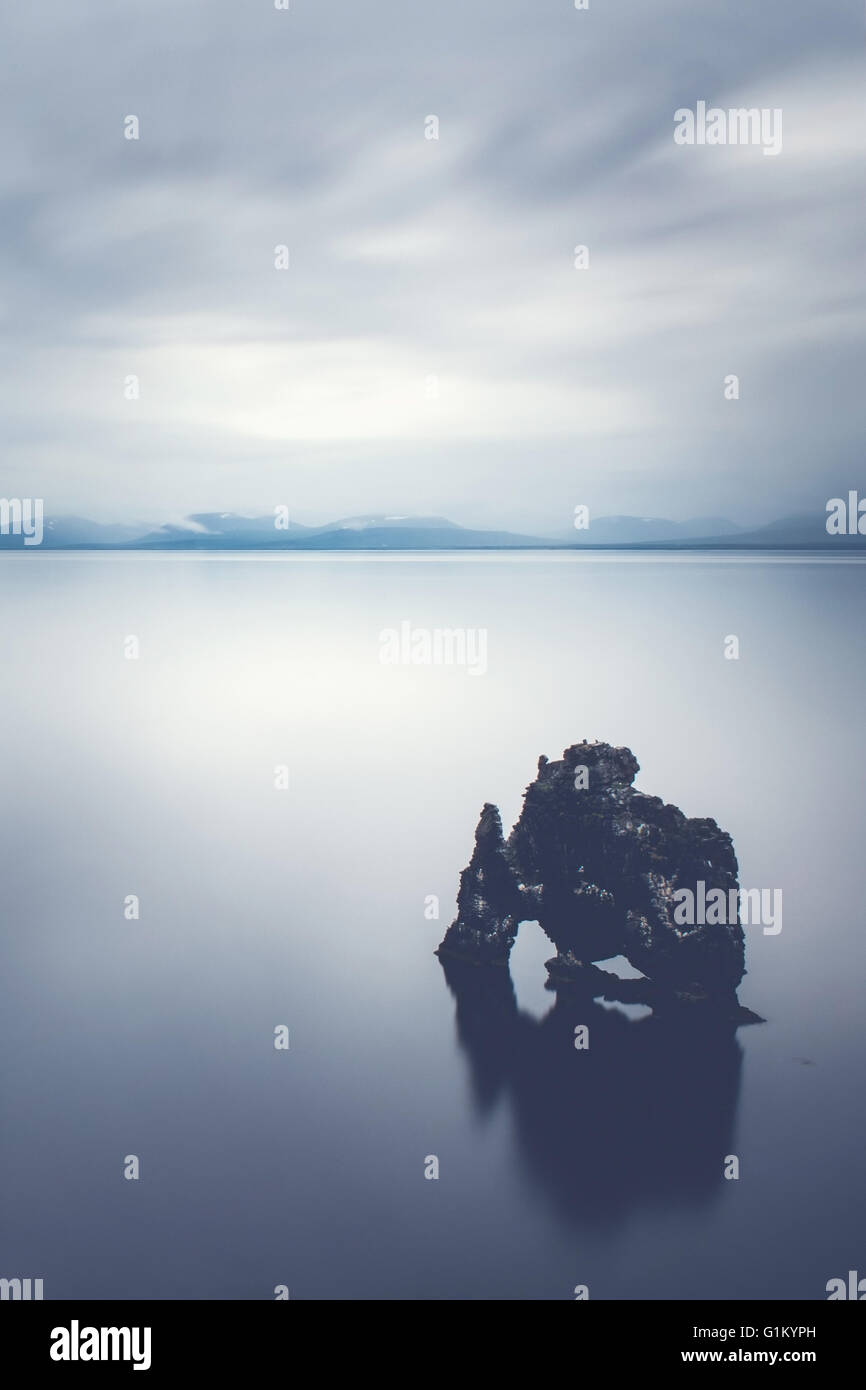 Rock in the calm sea Stock Photo - Alamy