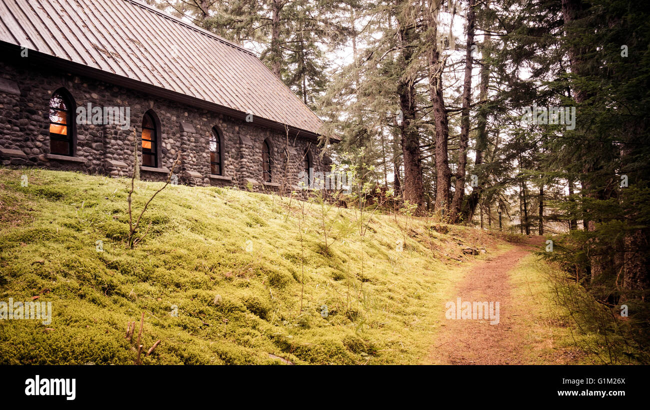 Stone church in the forest with a dirt path leading to the entrance ...