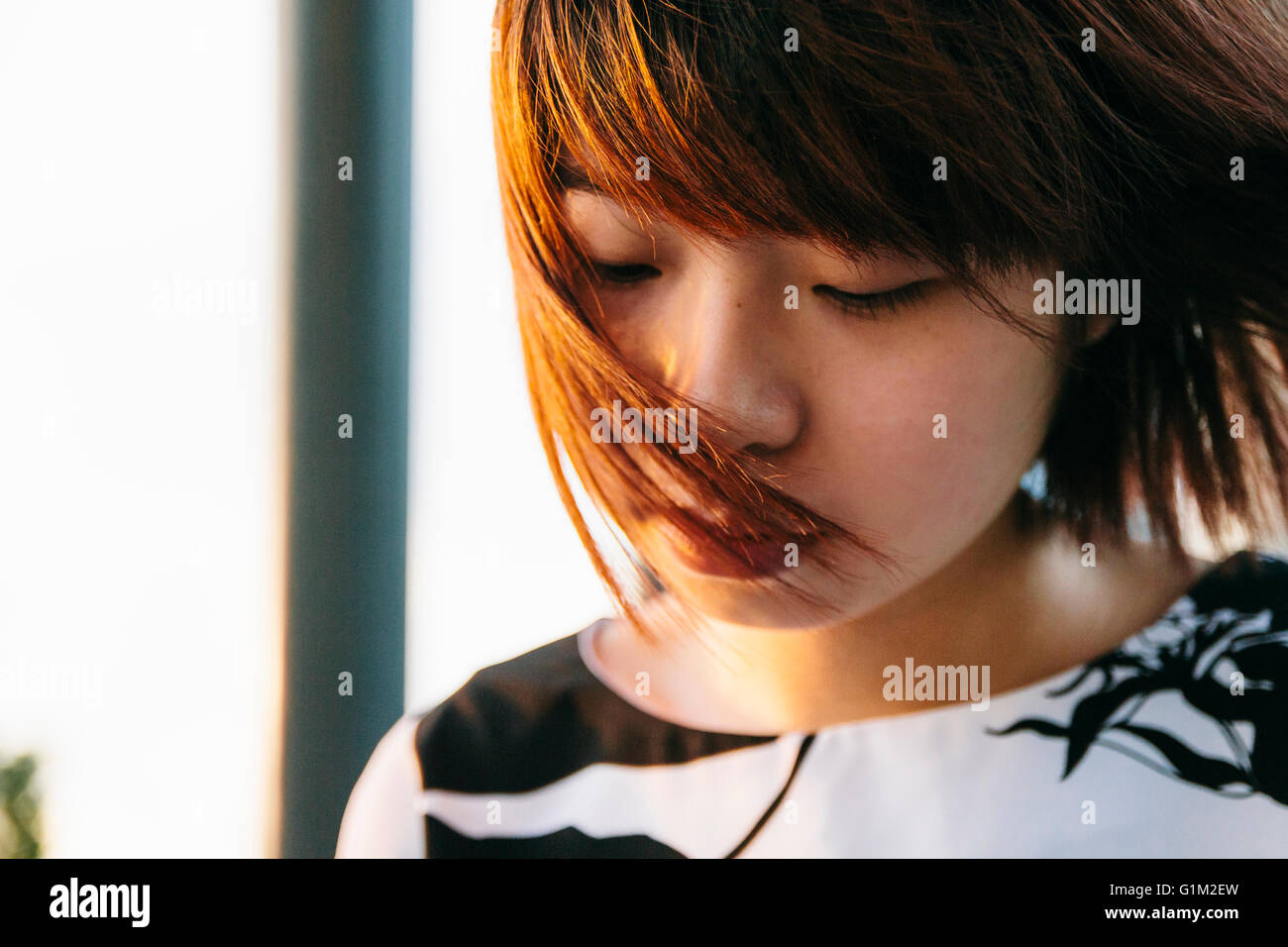 Hair of Chinese woman blowing in wind Stock Photo - Alamy