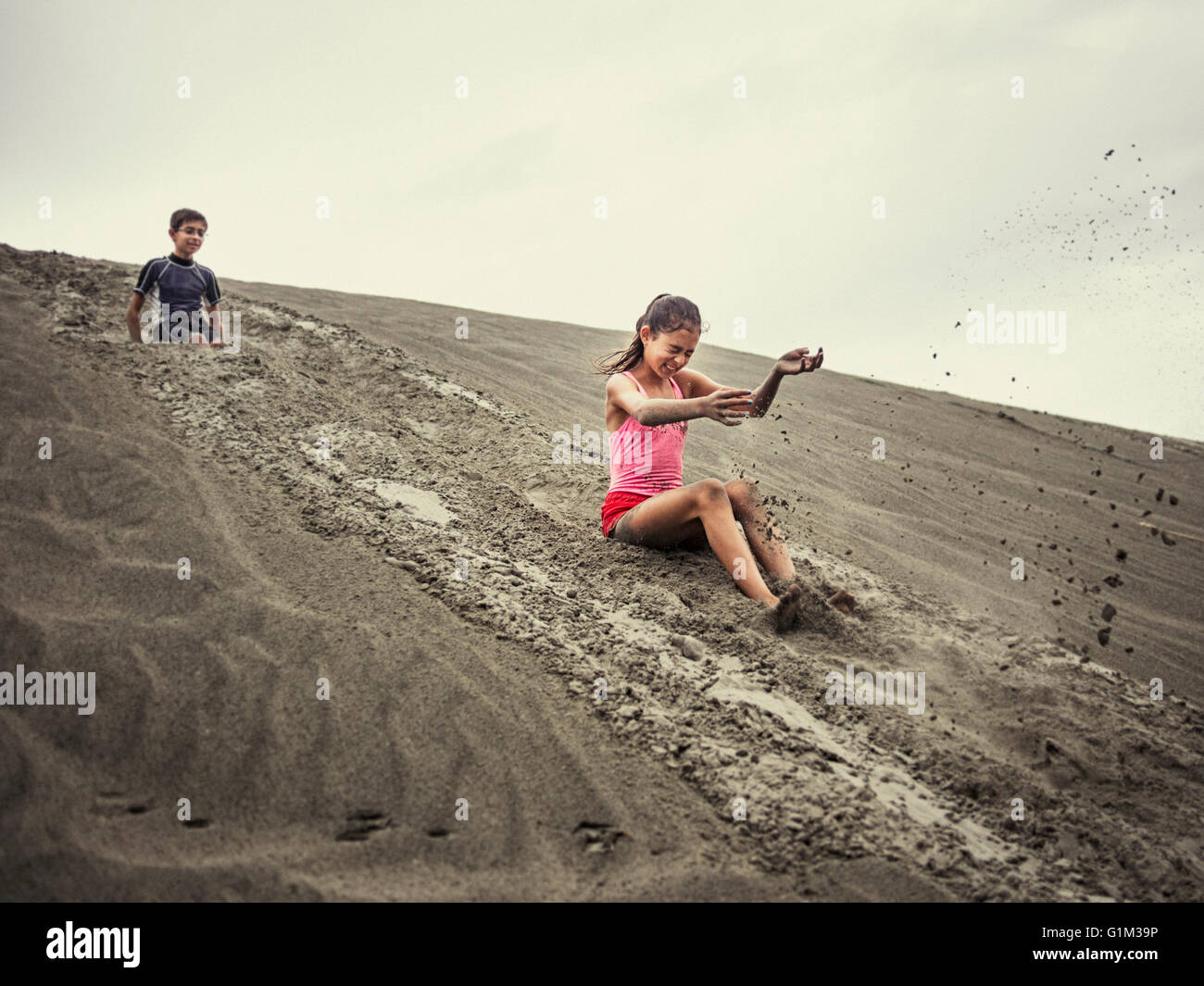 Children sliding on sand dune Stock Photo - Alamy